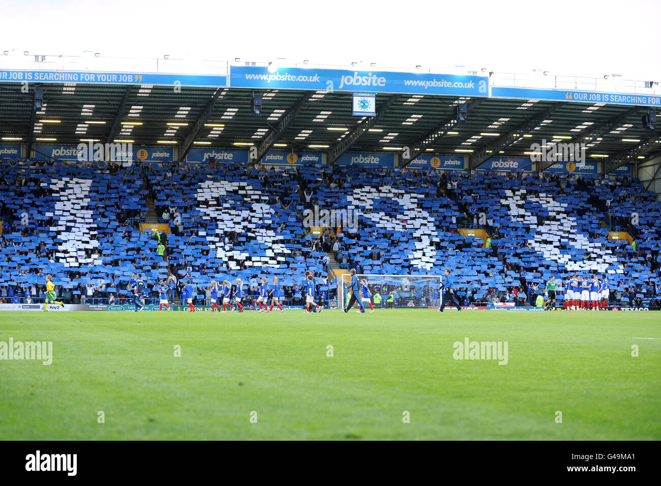 Portsmouth Fans Hold Up Coloured Card In The Stands To Spell Out The