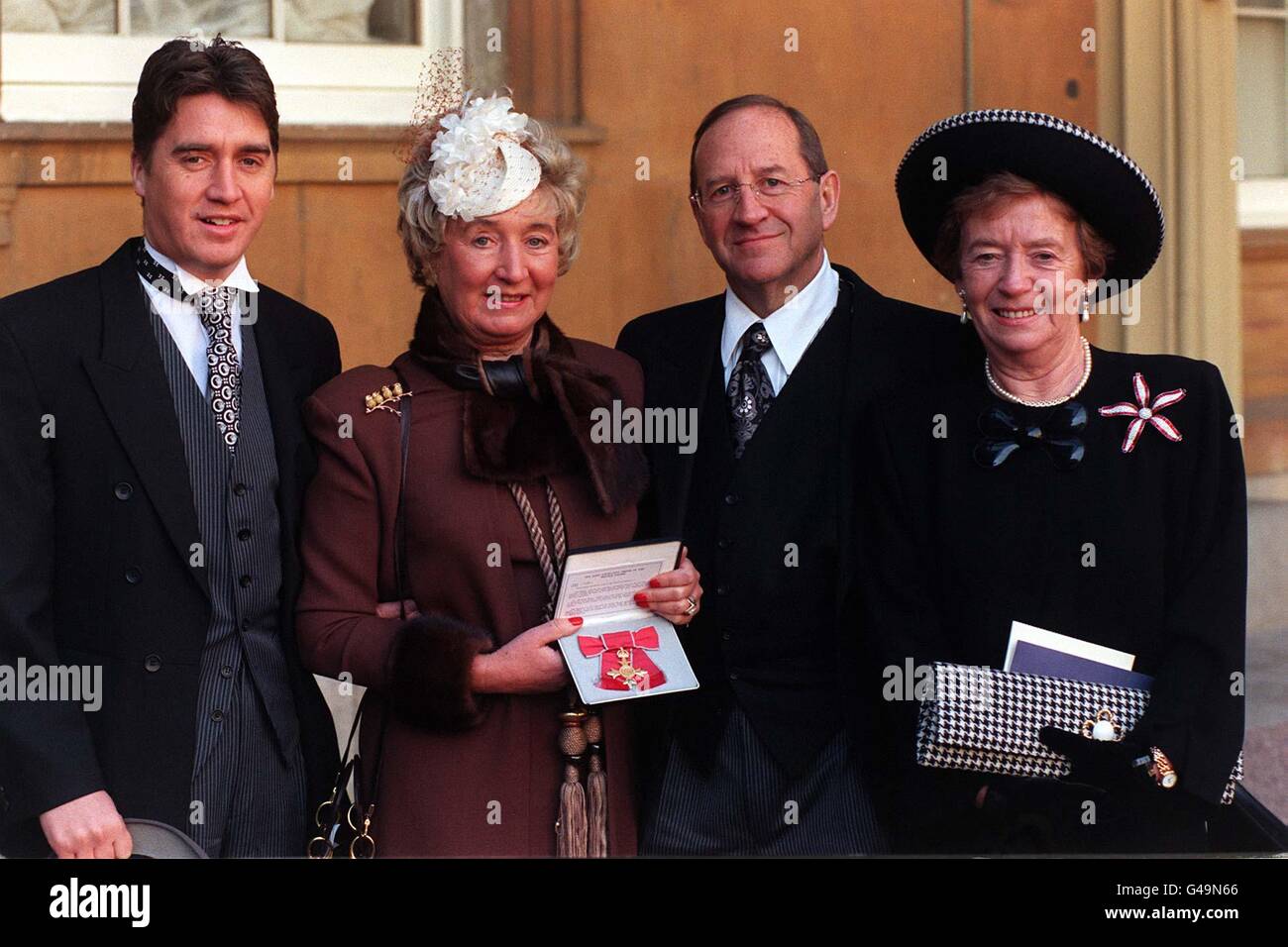 Vera Weisfeld, holds up her OBE as she poses with her son Michael ...