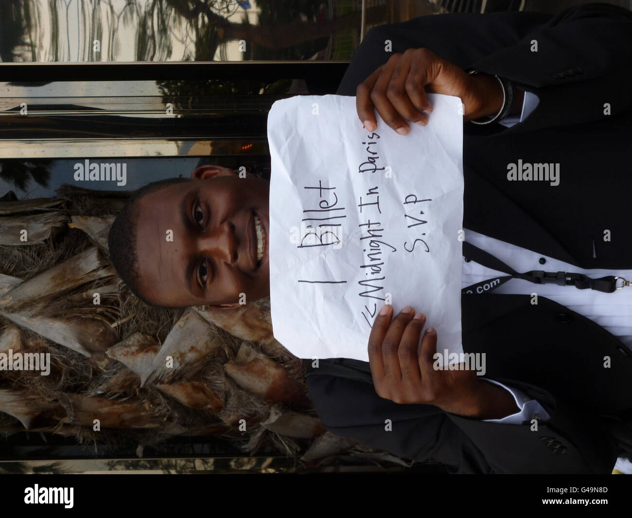 A desperate film fan holds up a sign asking for a ticket to tonight's ...