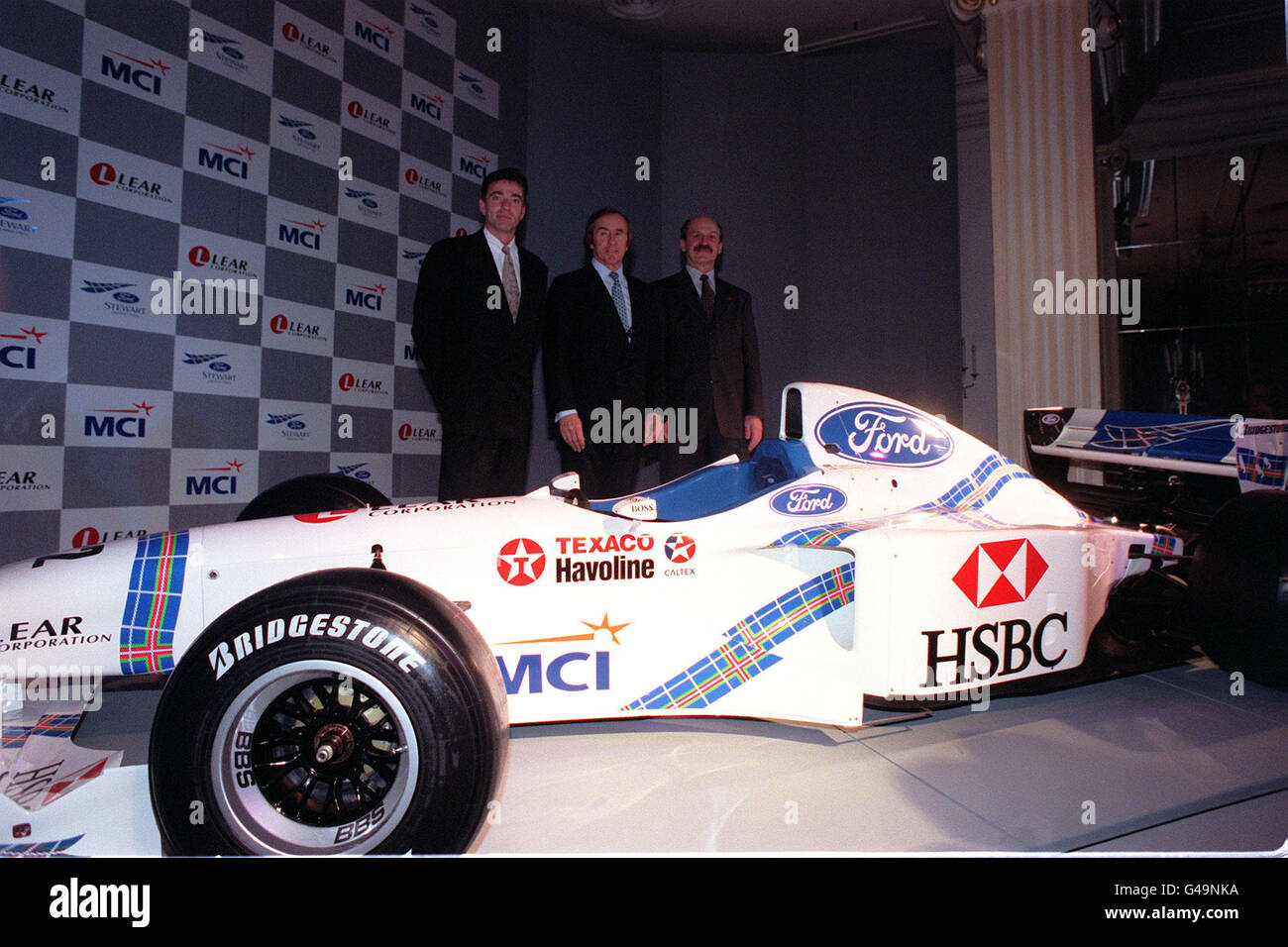 Jackie Stewart (centre), chairman of Stewart Grand Prix, unveils two ...