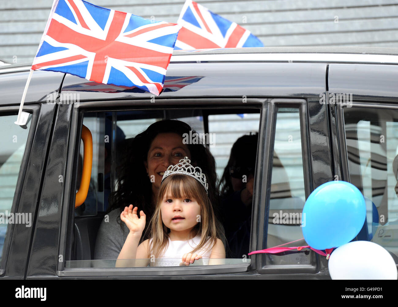 A young girl dressed as a princess travels in a taxi on The Mall in ...