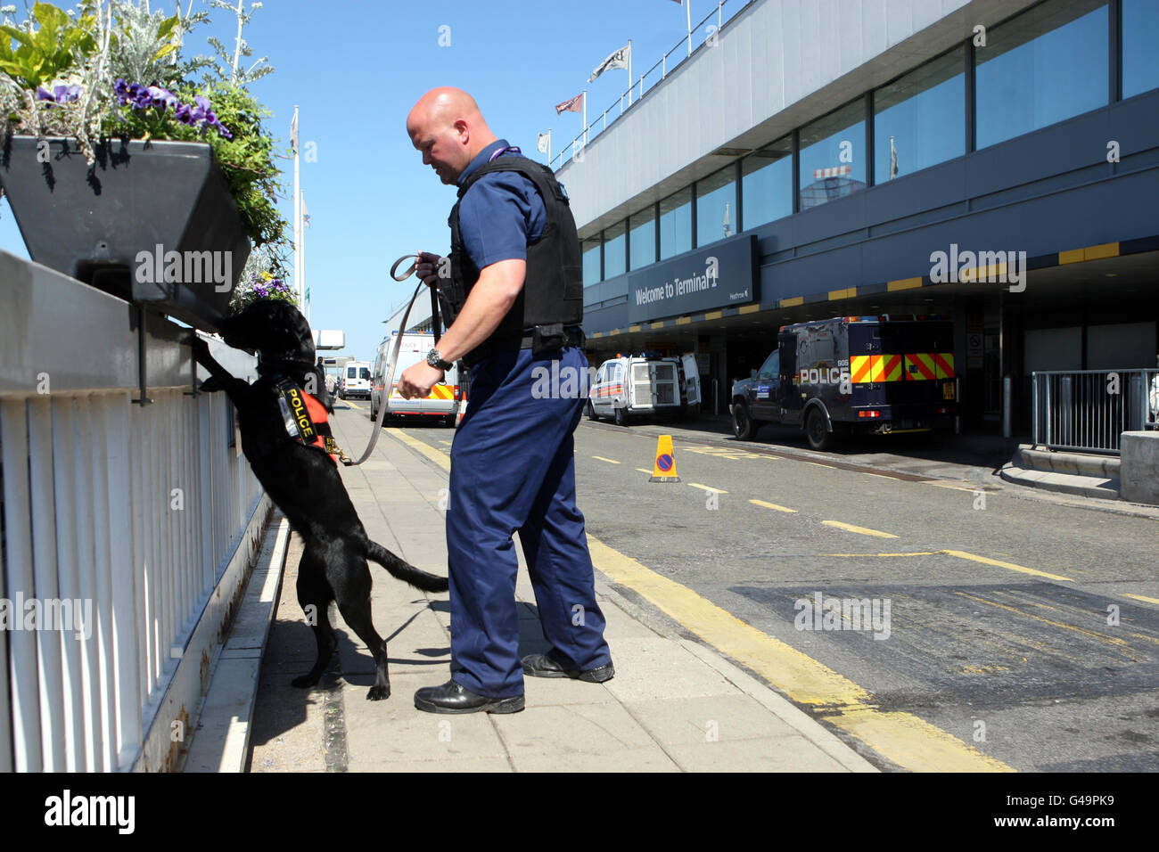 Police officers and their search dogs carry out routine searches of ...