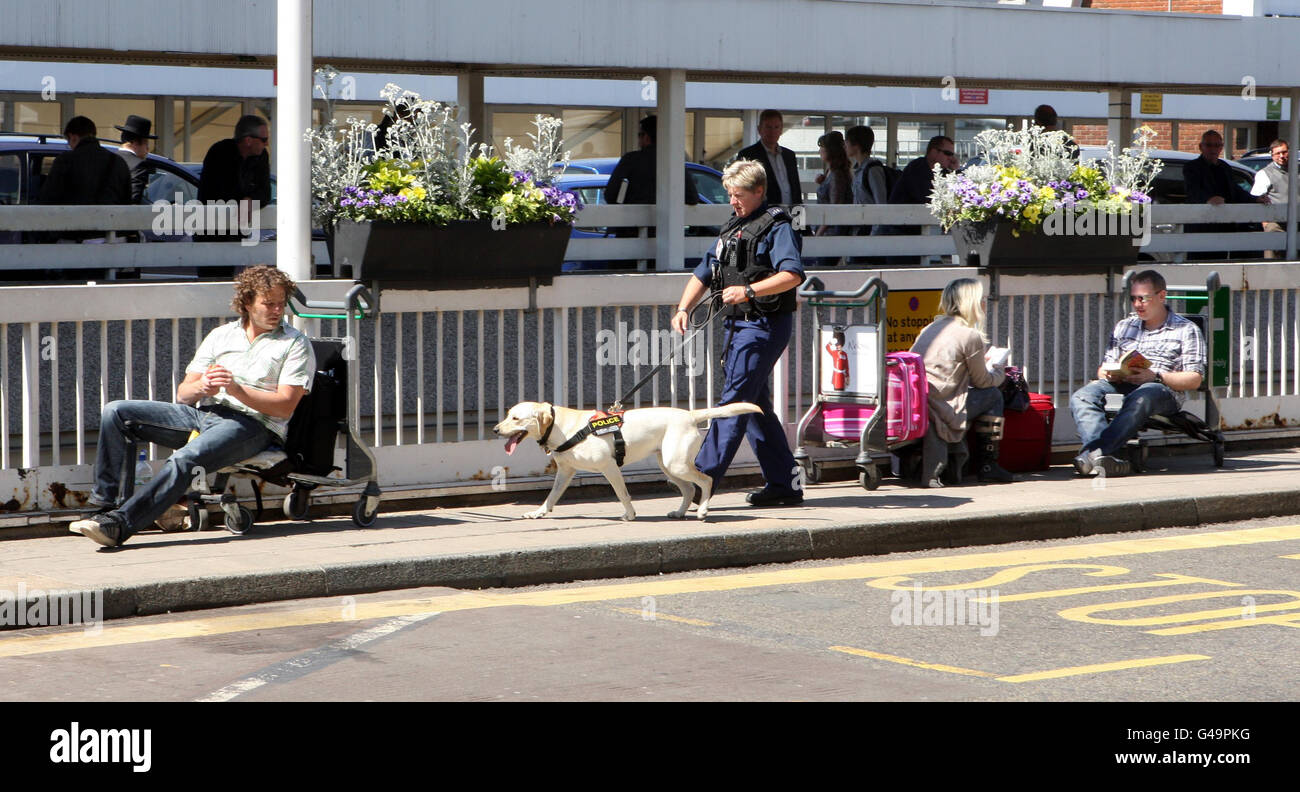 Police officers and their search dogs carry out routine searches of ...