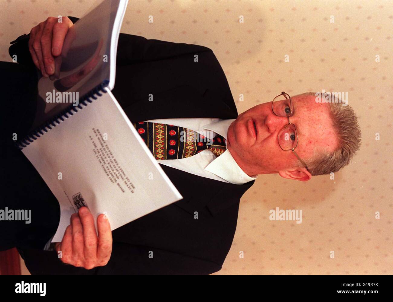 FA chief executive, Graham Kelly, holds the hard-hitting report ...
