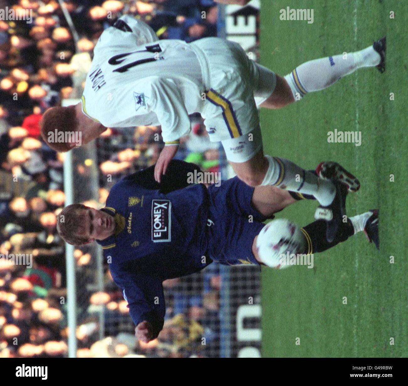 Wimbledon's Ben Thatcher (left) and David Hopkin of Leeds try to take ...