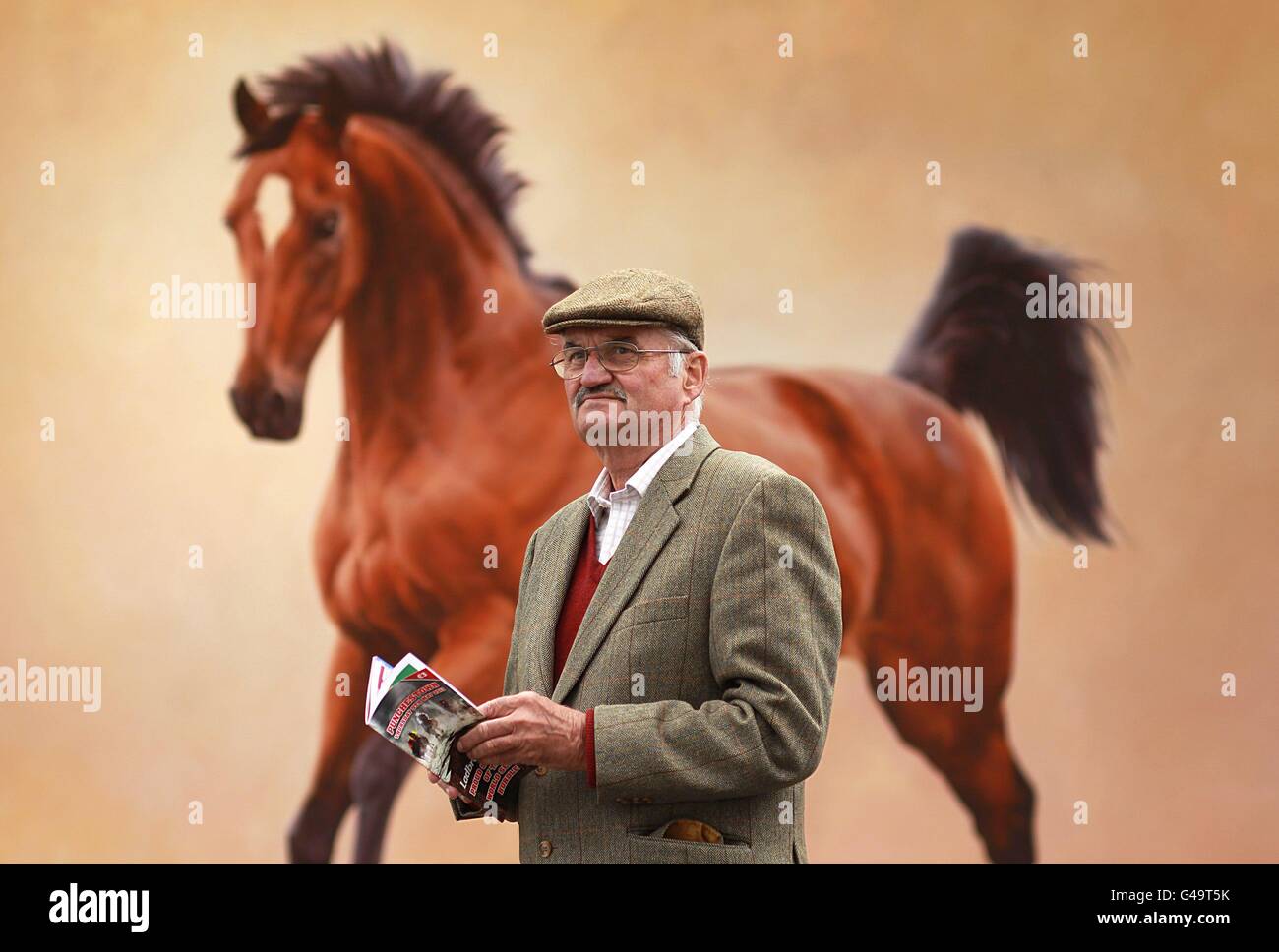 A racegoer reads the race card in front of Europe's largest Equine ...