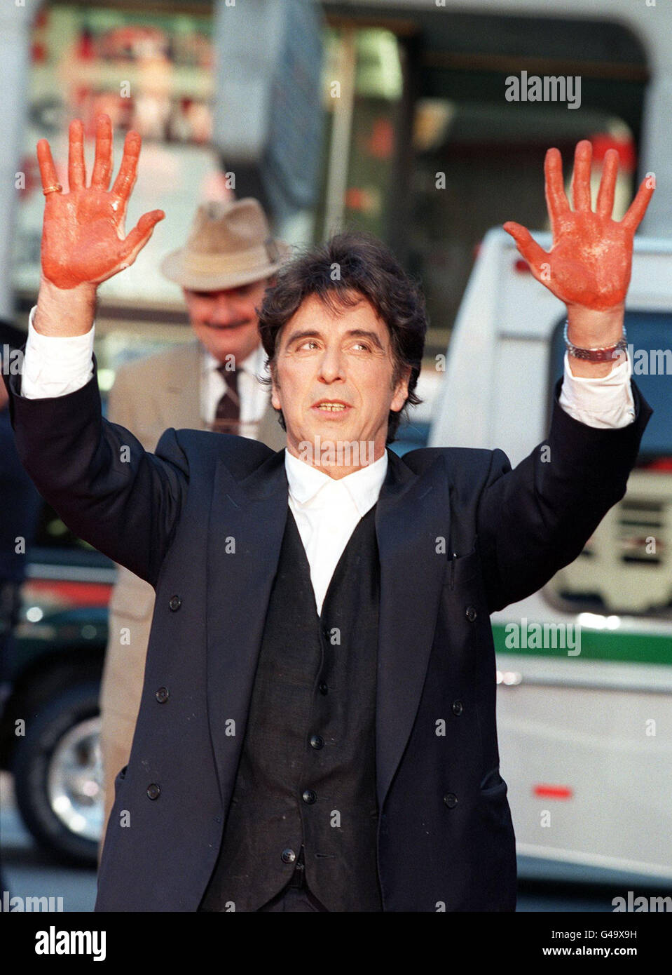 Academy Award winning actor Al Pacino raises his hands after imprinting ...