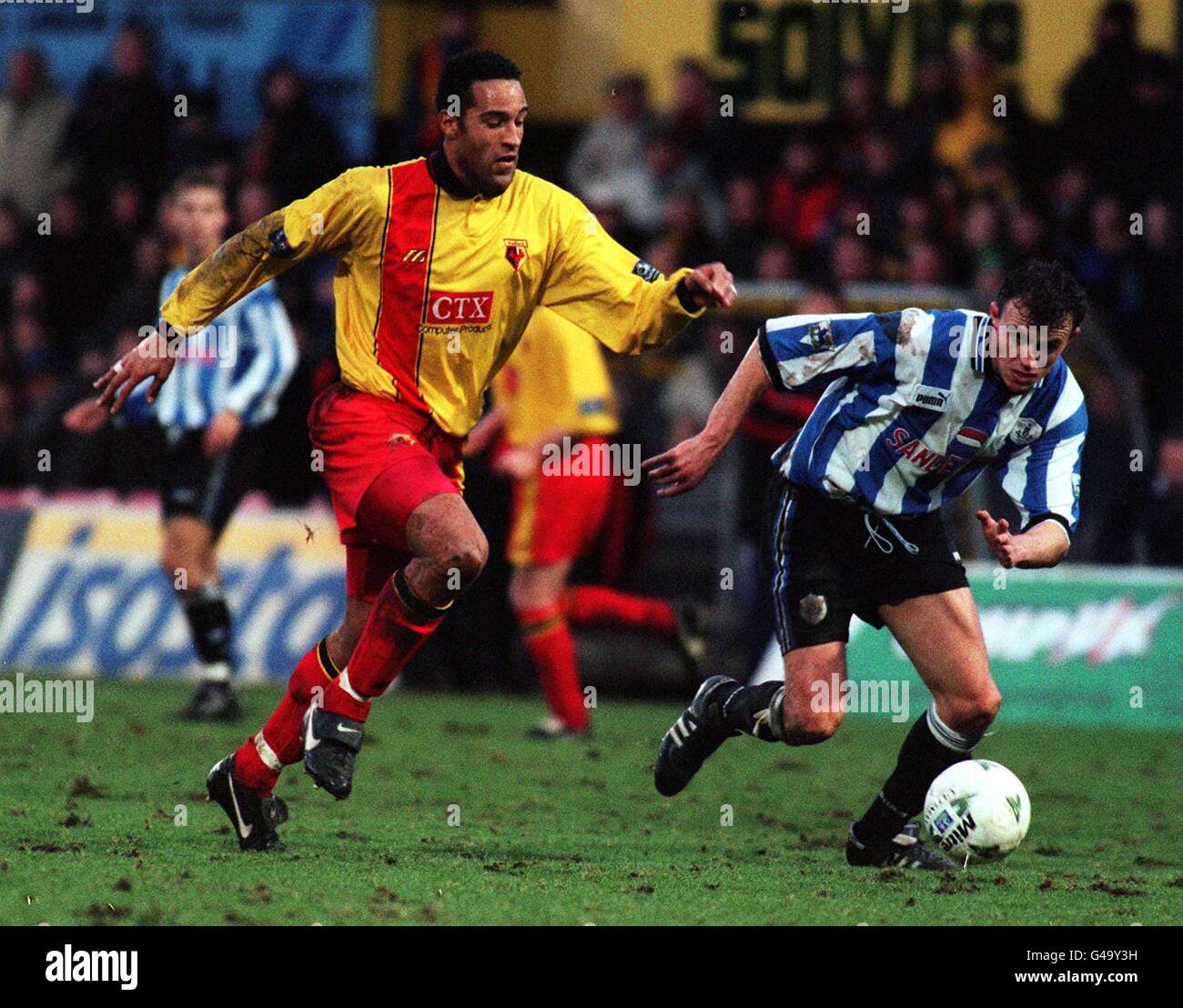 Watford's Jason Lee (L) attacks the ball as Sheffield Wednesday's ...