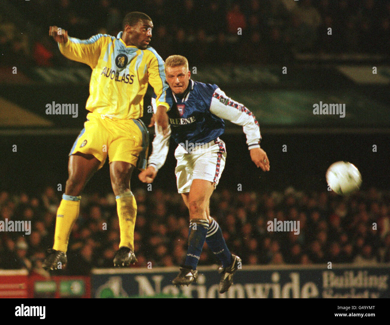 Chelsea's Bernard Lambourde (left) jumps with Ipswich's Alex Mathie ...