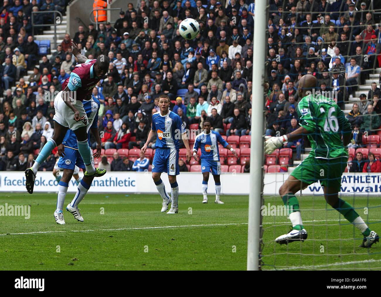 West Ham United's Demba Ba (left) heads home the opening goal of the ...