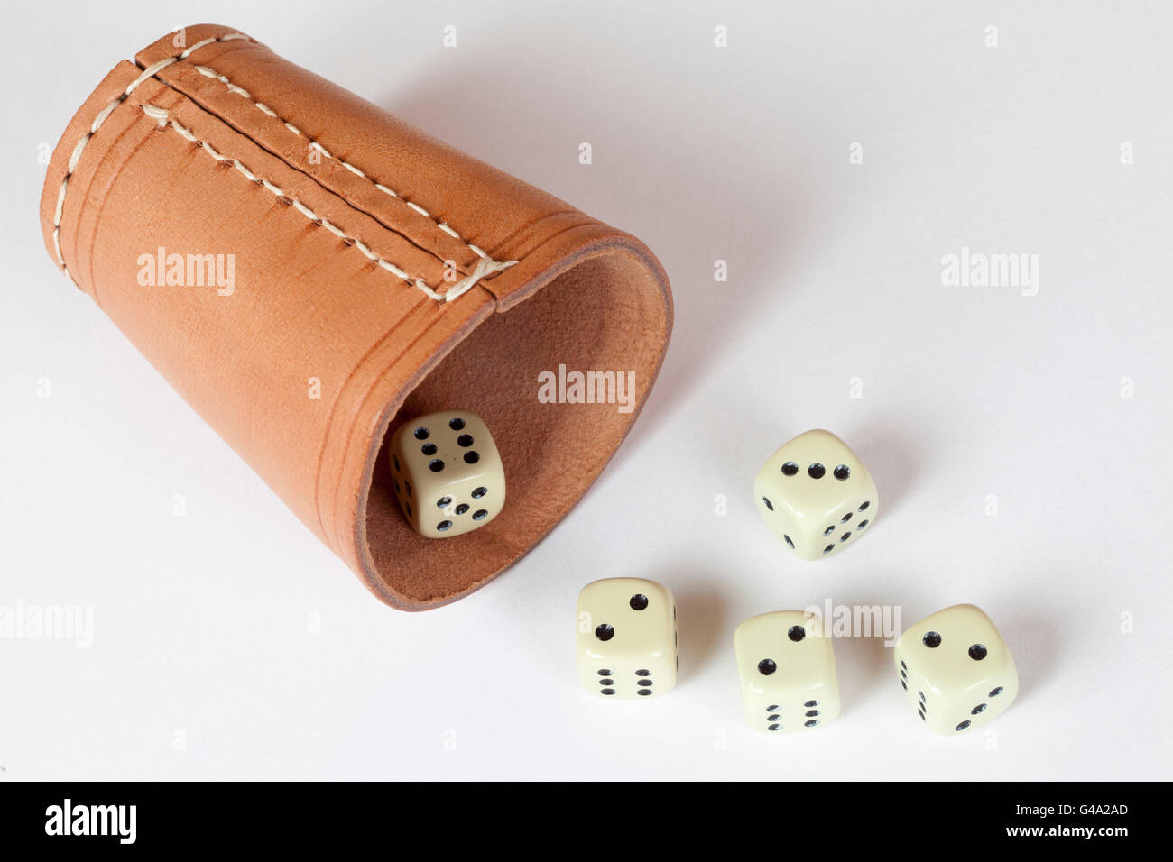 Dice cup with dice Stock Photo - Alamy