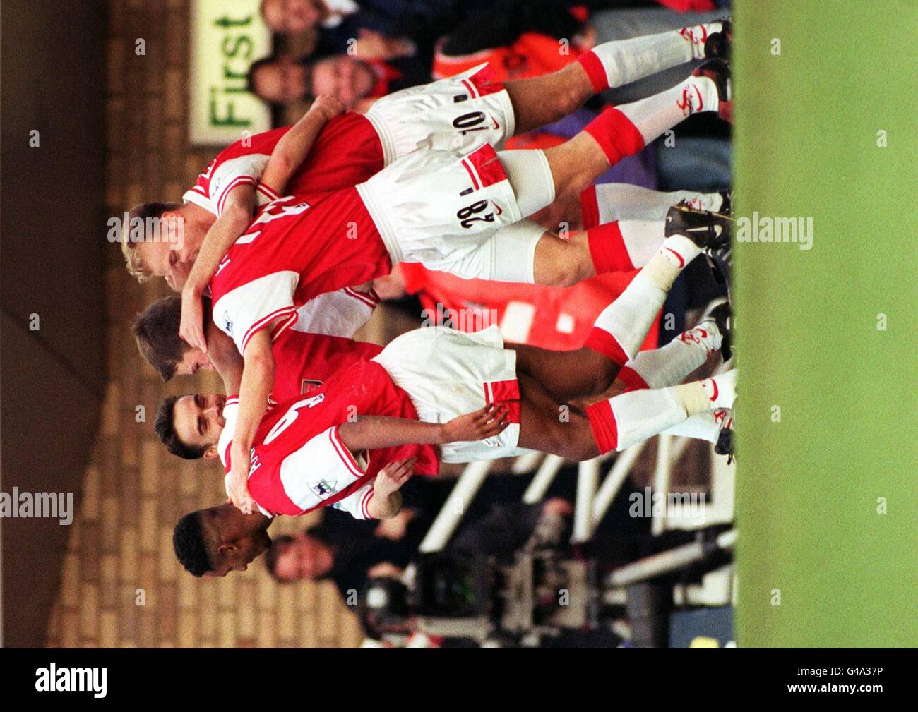 Arsenal's Stephen Hughes (centre, 28) is congratulated by teammates ...