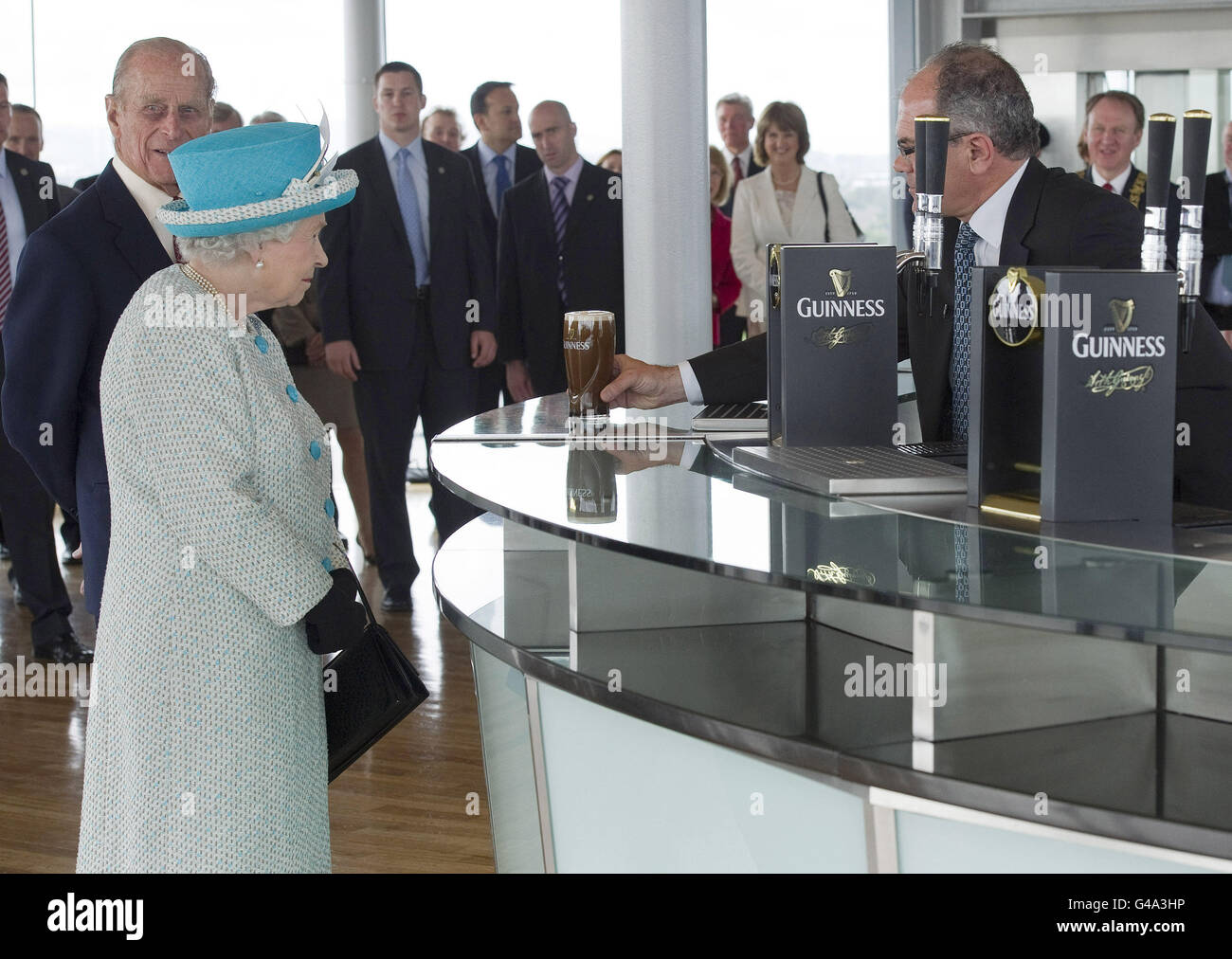 Queen Elizabeth II and the Duke of Edinburgh admire a pint of Guinness ...