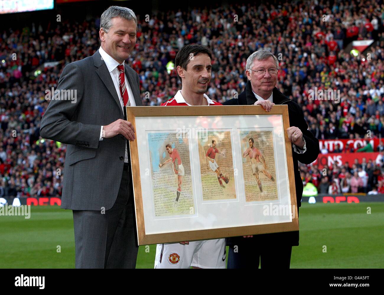 Manchester United's Gary Neville is presented with a special ...