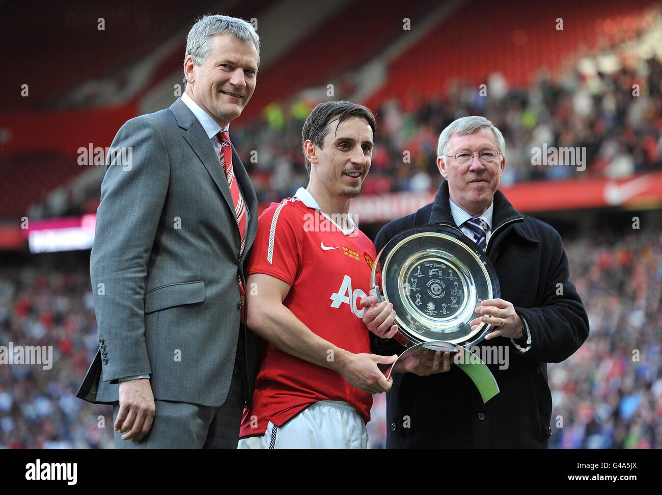 Manchester United's Gary Neville is presented with a special ...