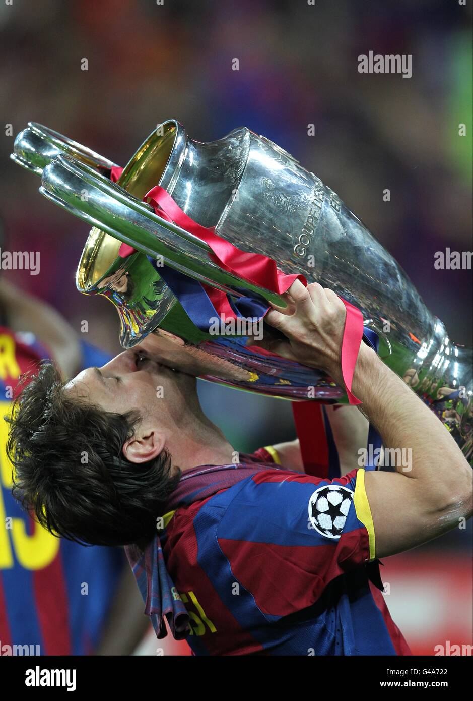 Barcelonas lionel messi celebrates kissing the champions league trophy ...