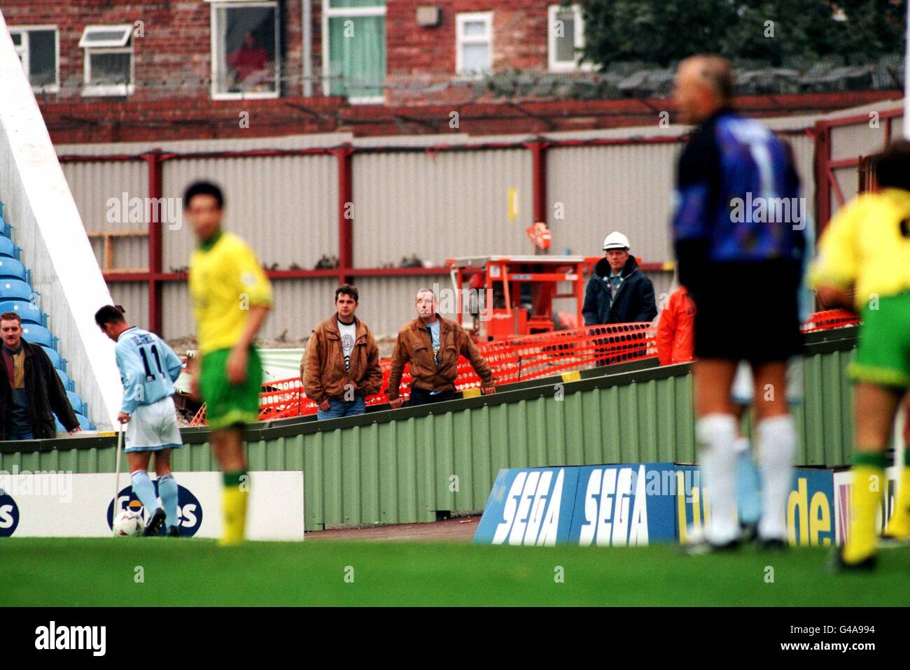 SOCCER. WORKMEN WATCH FROM THE BUILDING WORK IN THE CORNER OF THE OLD ...