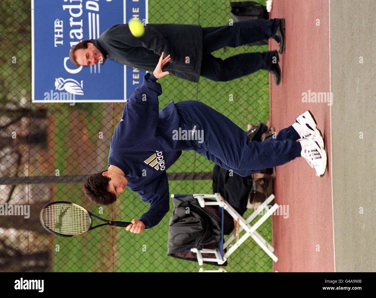 Brtish tennis ace Tim Henman strikes a pose which amuses a passer-by ...