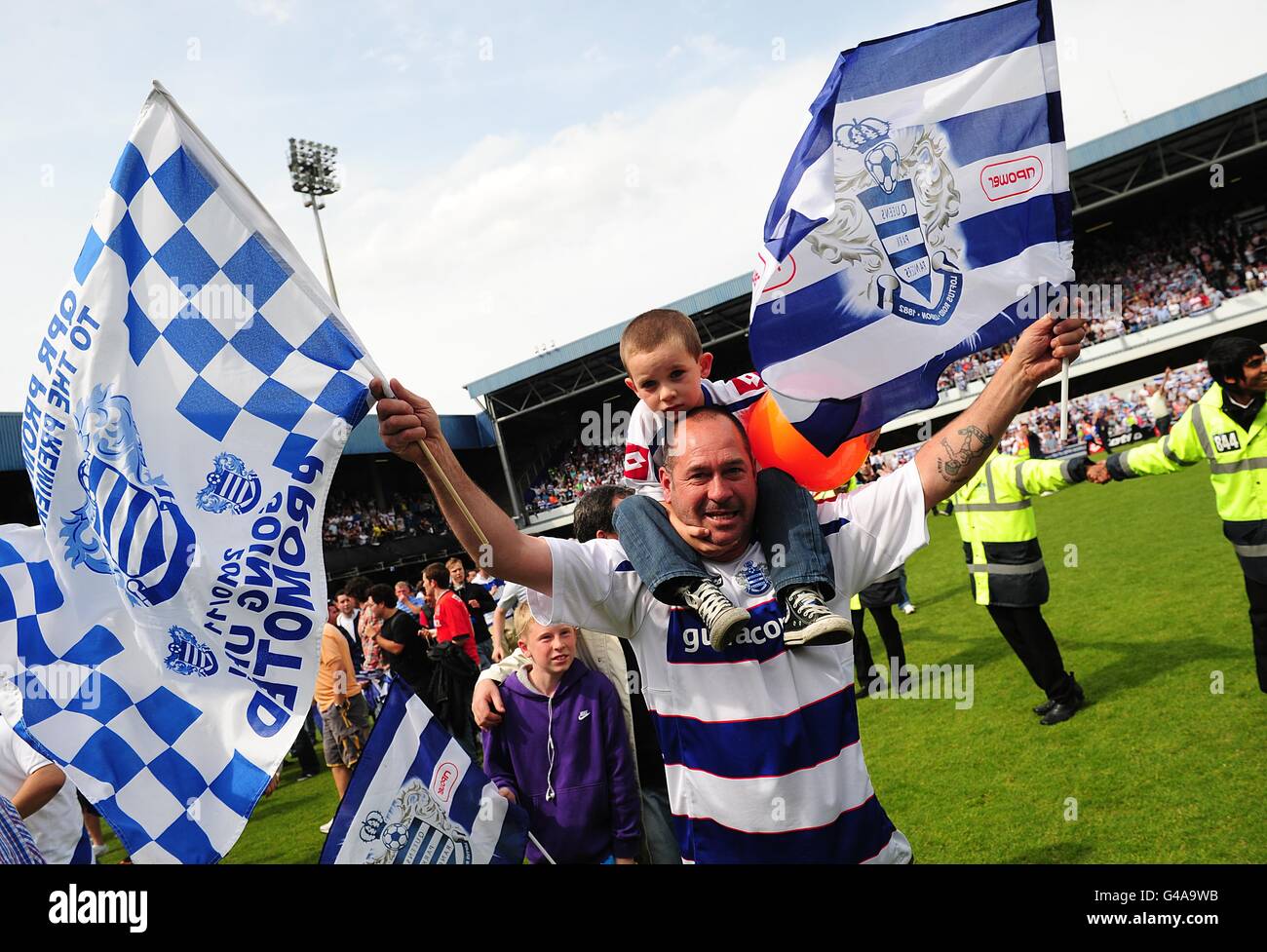 Queens Park Rangers fans on the pitch celebrate their side finishing ...