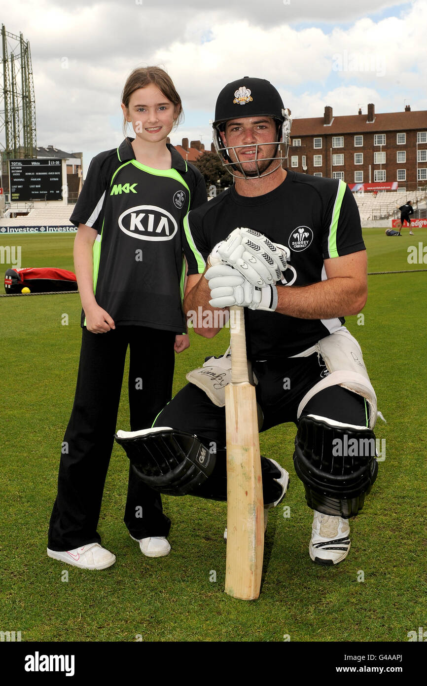 Surrey's Tom Maynard (right) poses for a photograph with the mascot ...