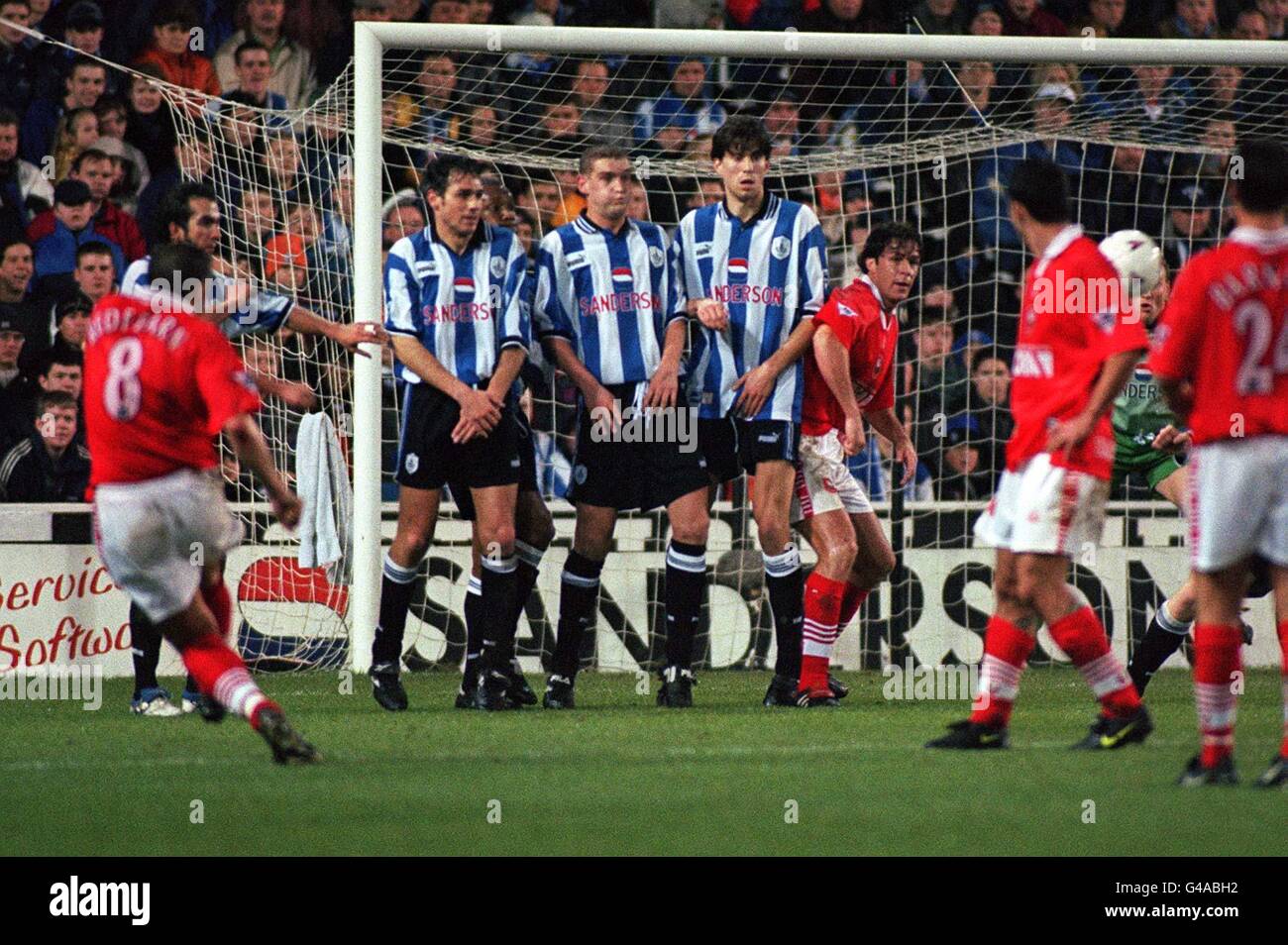 Finding the gap, Neil Redfearn the Barnsley Captain hits a freekick to ...