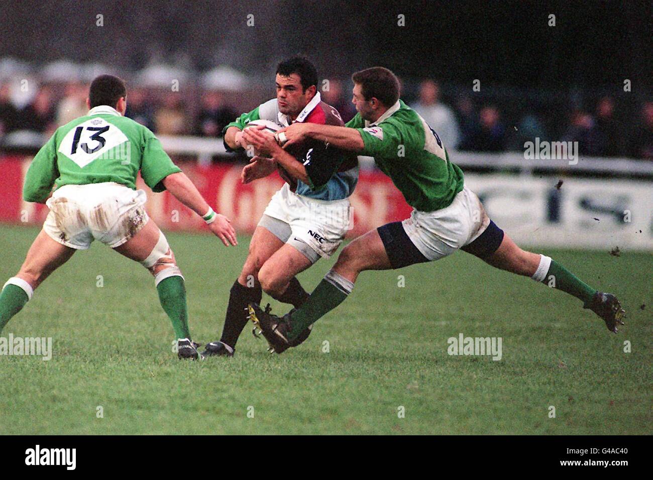 Harlequins' Will Carling (centre) fights his way through Nick Burrows ...