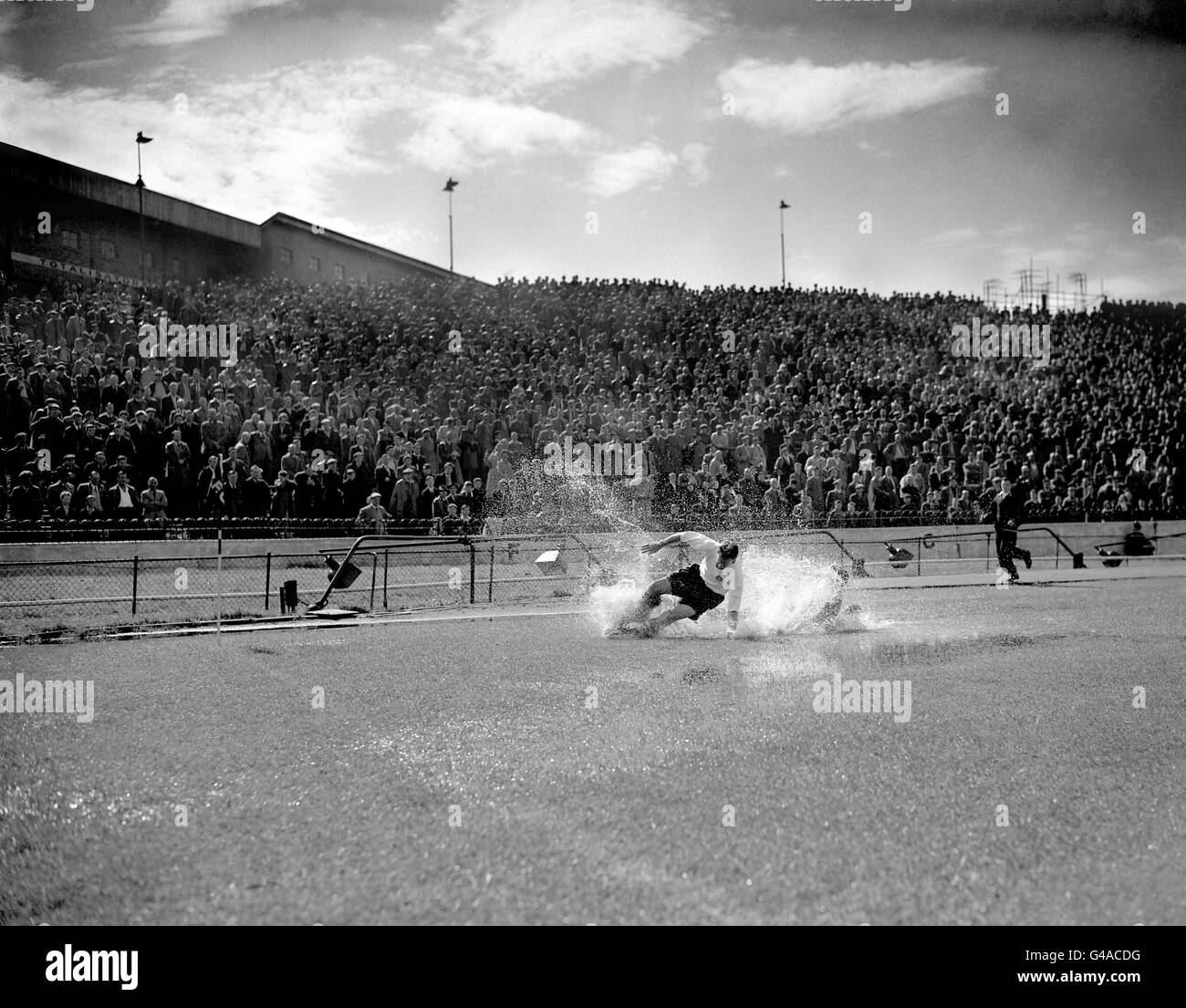 Tom Finney, England and Preston North End forward, in a shower of water ...