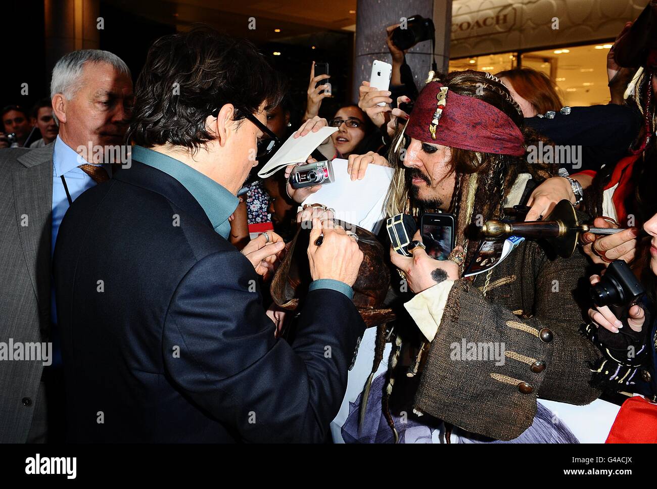 Johnny Depp signs autographs for fans as he arrives for the UK film ...