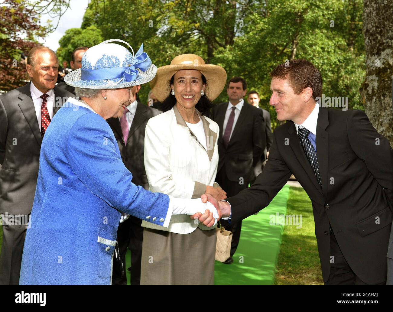 Queen Elizabeth II shakes hands with Jonny Murtagh during a visit to ...