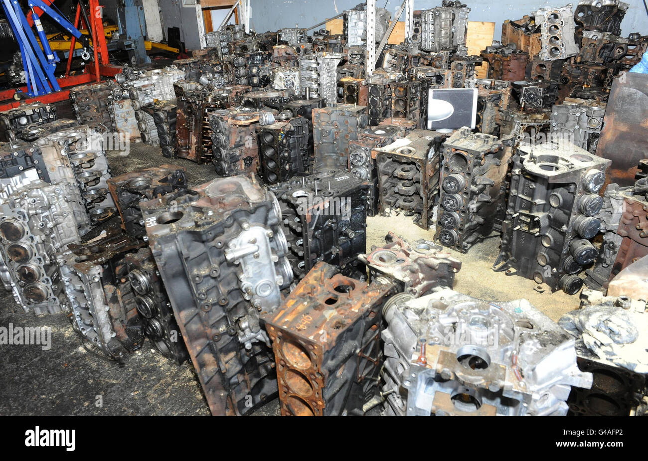 Garage raid in London. Engine parts are seen as police officers raid ...