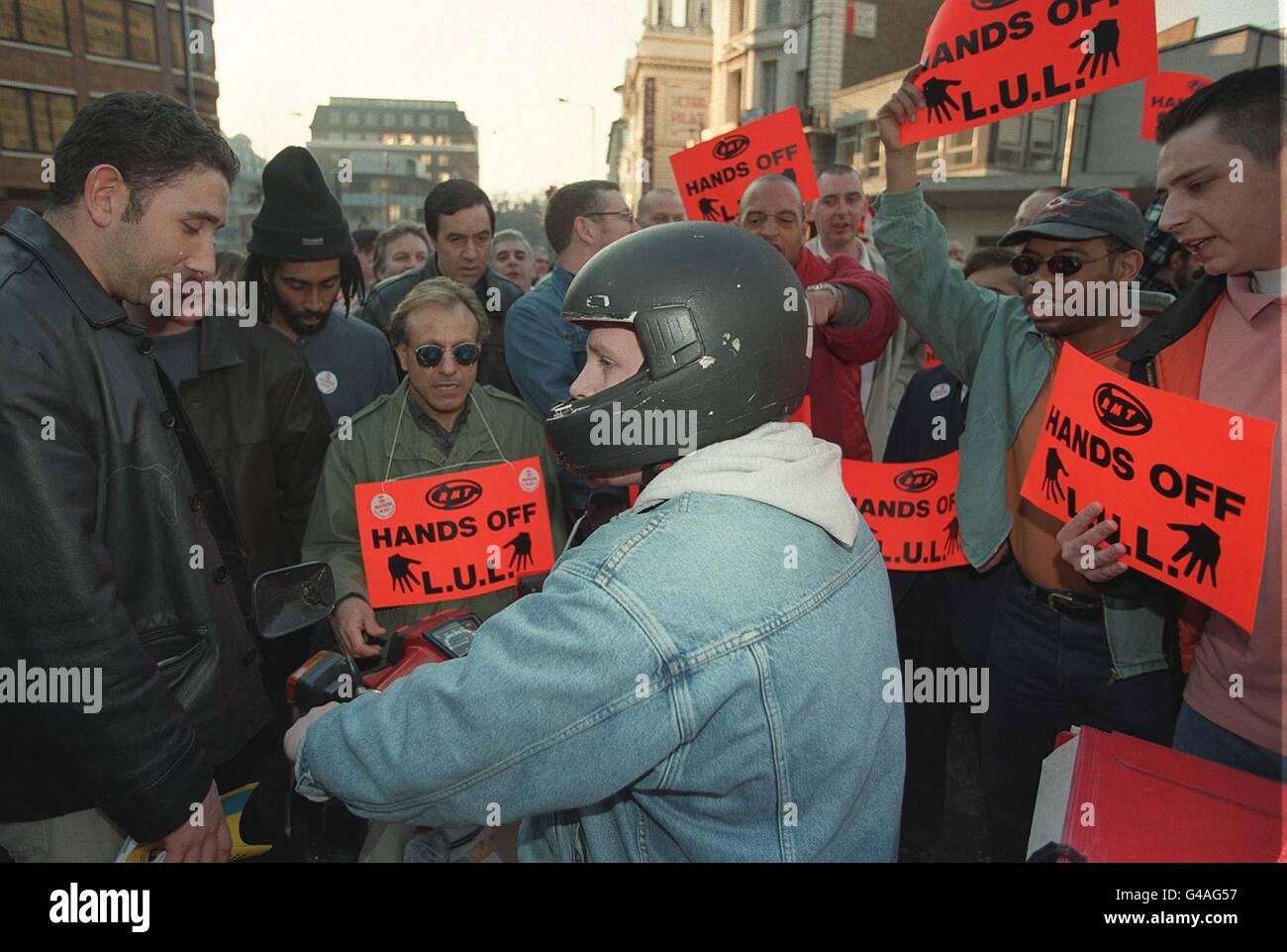 A pizza delivery rider is confronted by protesters as members of the ...