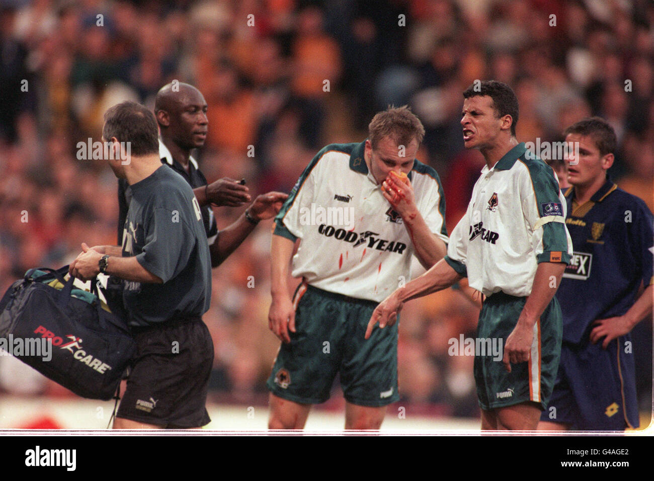 Wolves captain Keith Curle (right) encourages team physio Barry Holmes ...