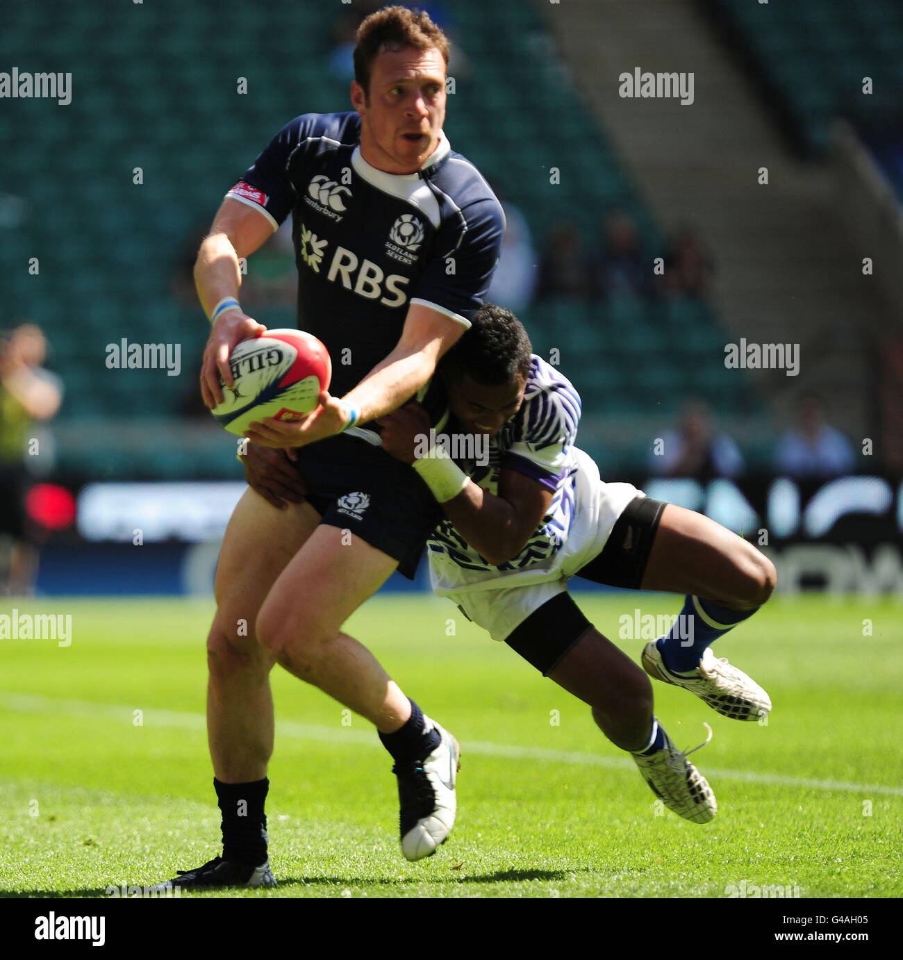 Scotland's Scott Riddell (left) offloads the ball before being tackled ...