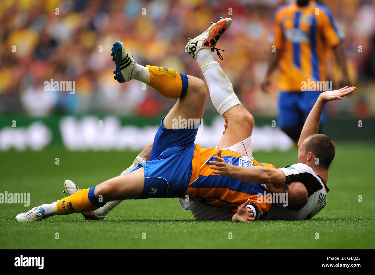 Darlington's Liam Hatch (right) and Mansfield Town's Adam Murray fall ...