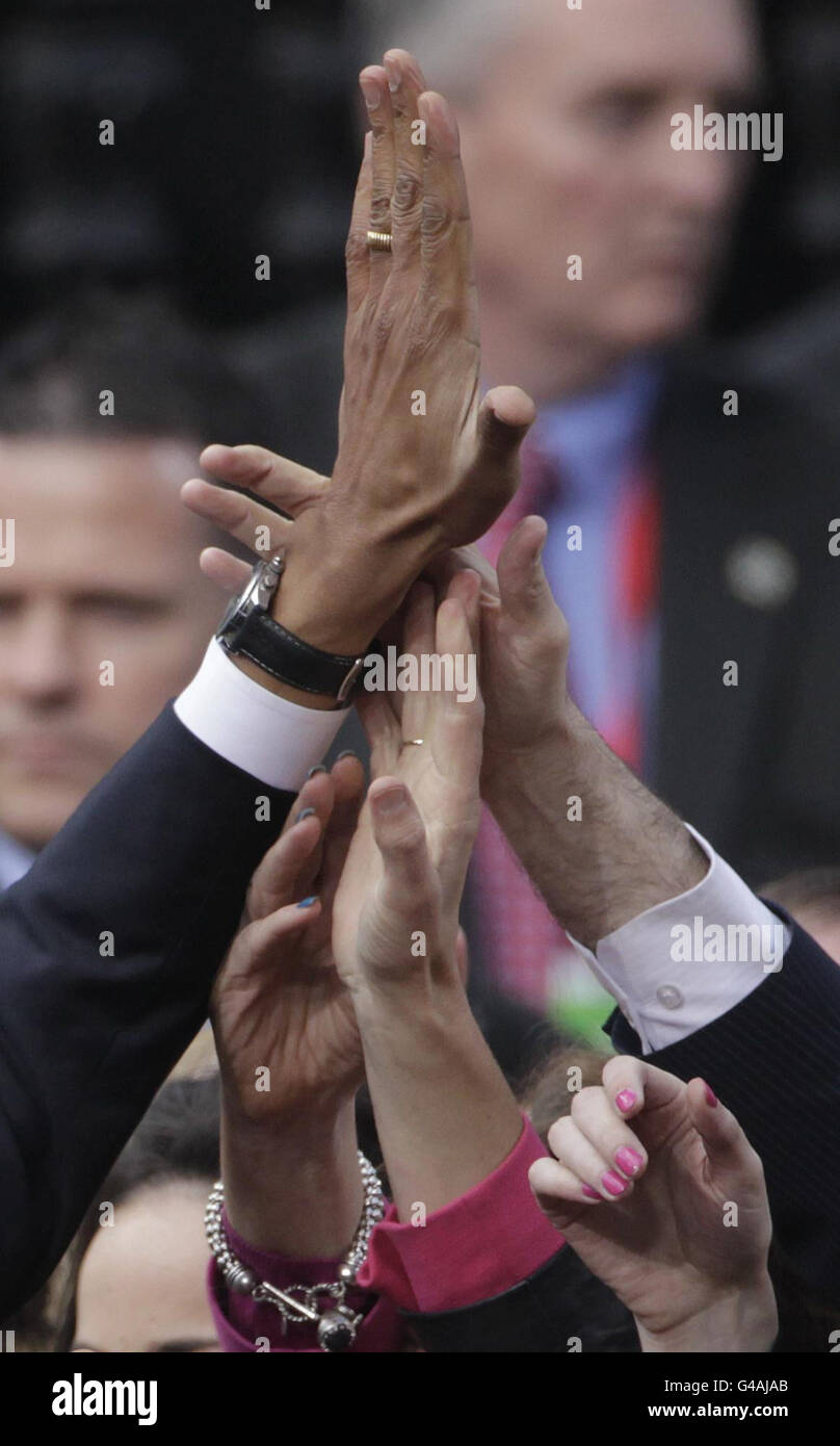US President Barack Obama gives a high five to a well wisher after his ...