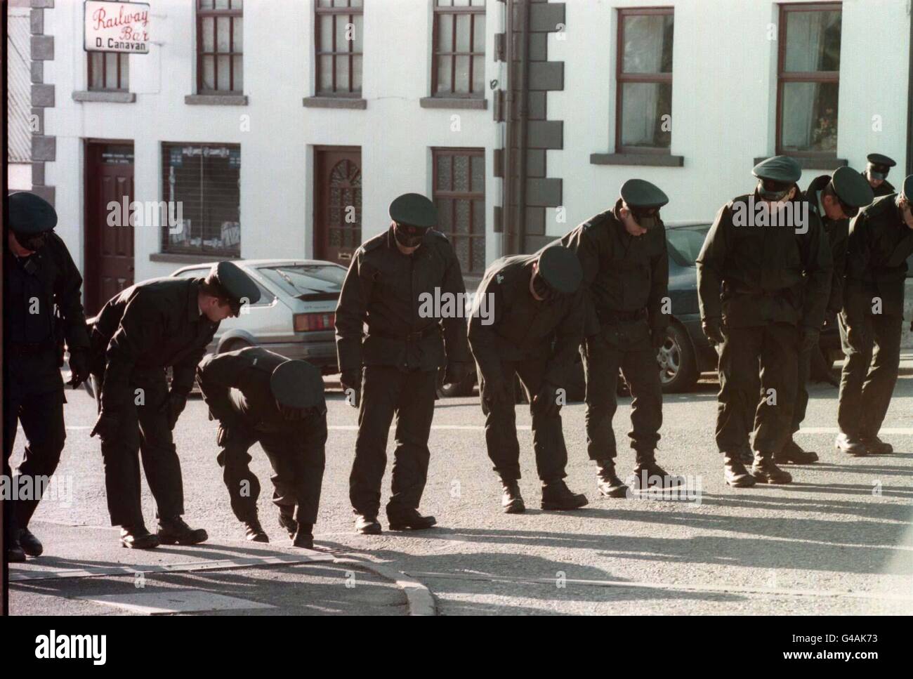 RUC officers search the street in front of the Railway Bar in ...