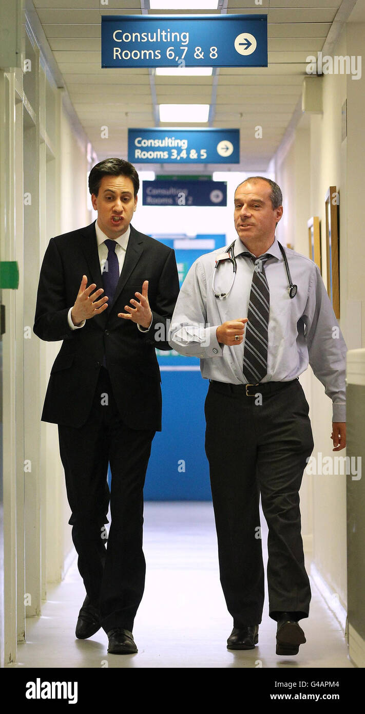 Labour Party leader Ed Miliband (left) walks with Doctor Tom Coffey at ...