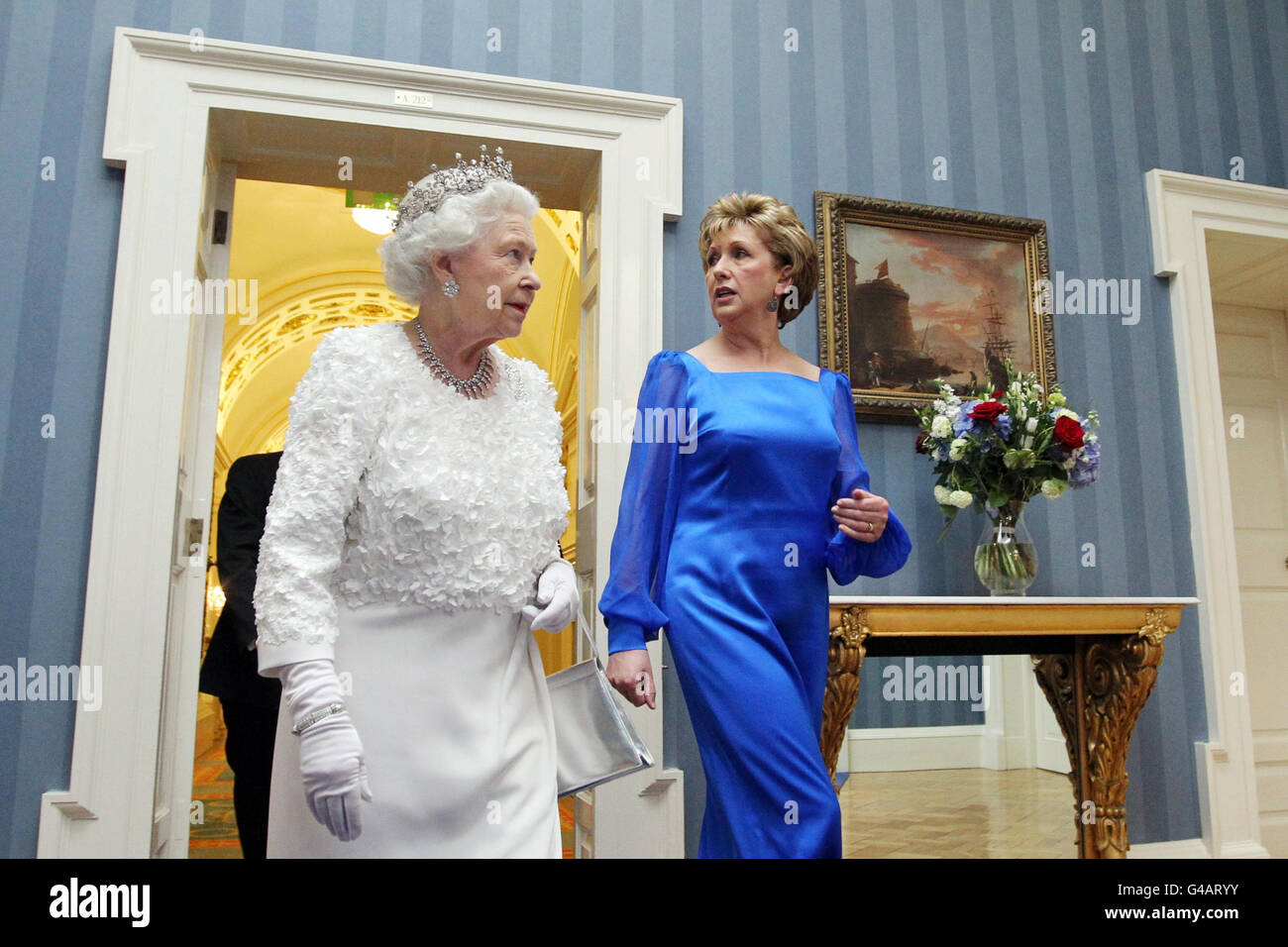 Britain's Queen Elizabeth II walks with Irish President Mary McAleese ...