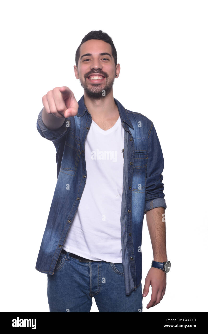 Portrait of young latin man pointing to camera. Isolated white ...