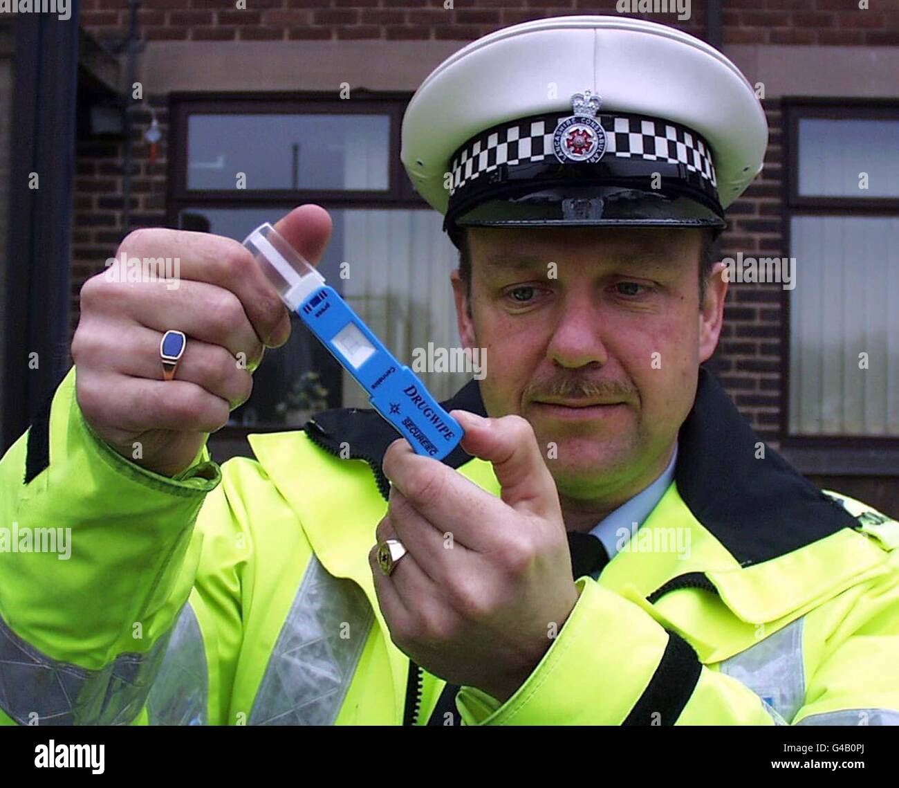 Sgt Martin Parry of Lancashire Police with a "Drugwipe", a roadside ...