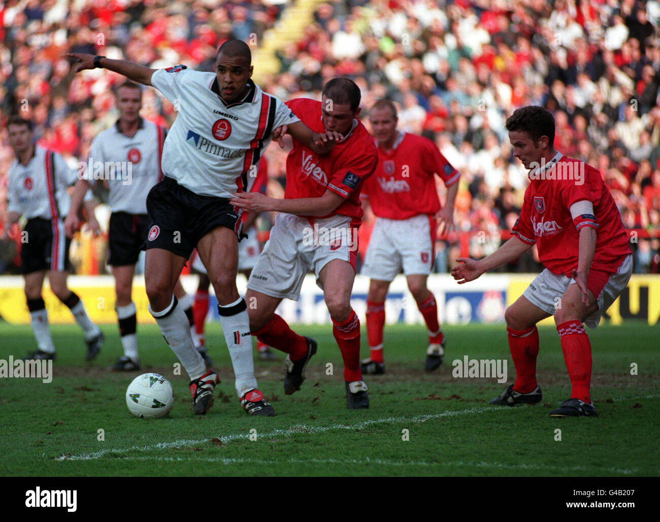 Pierre van Hooijdonk (left) of Notts Forest battles to keep possession ...