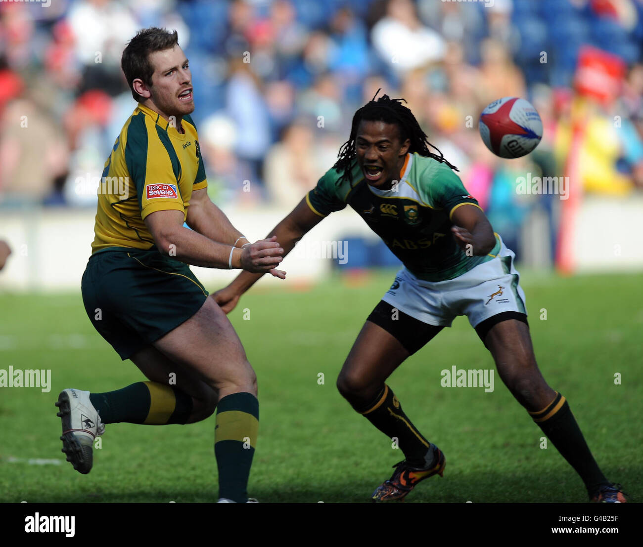 South Africa's Cecil Afrika and Australia's Bernard Foley in action ...