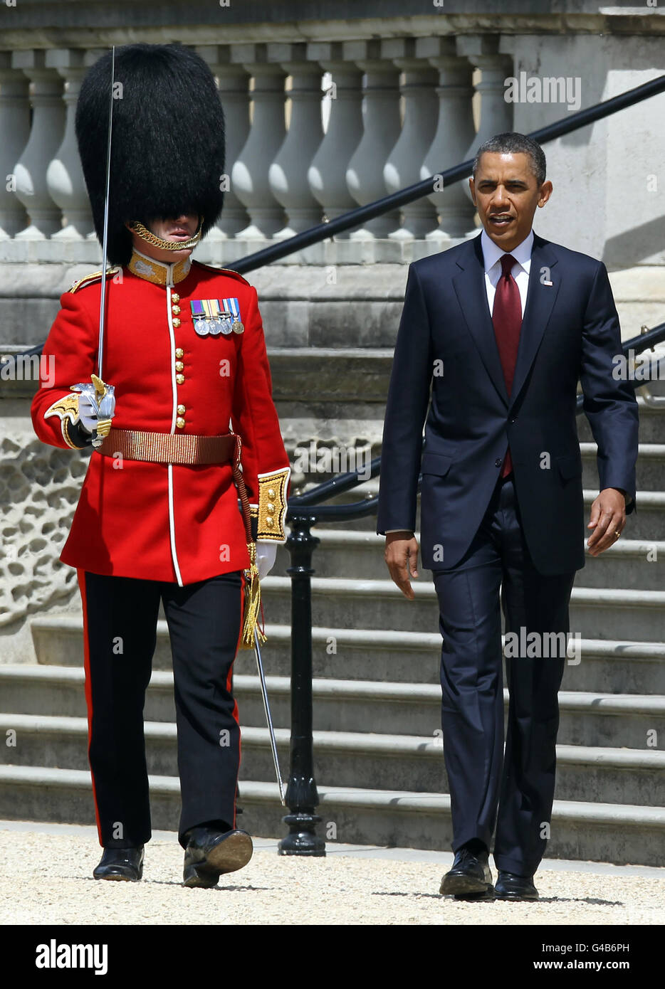 An officer from the Scots Guards leads US President Barack Obama TO ...