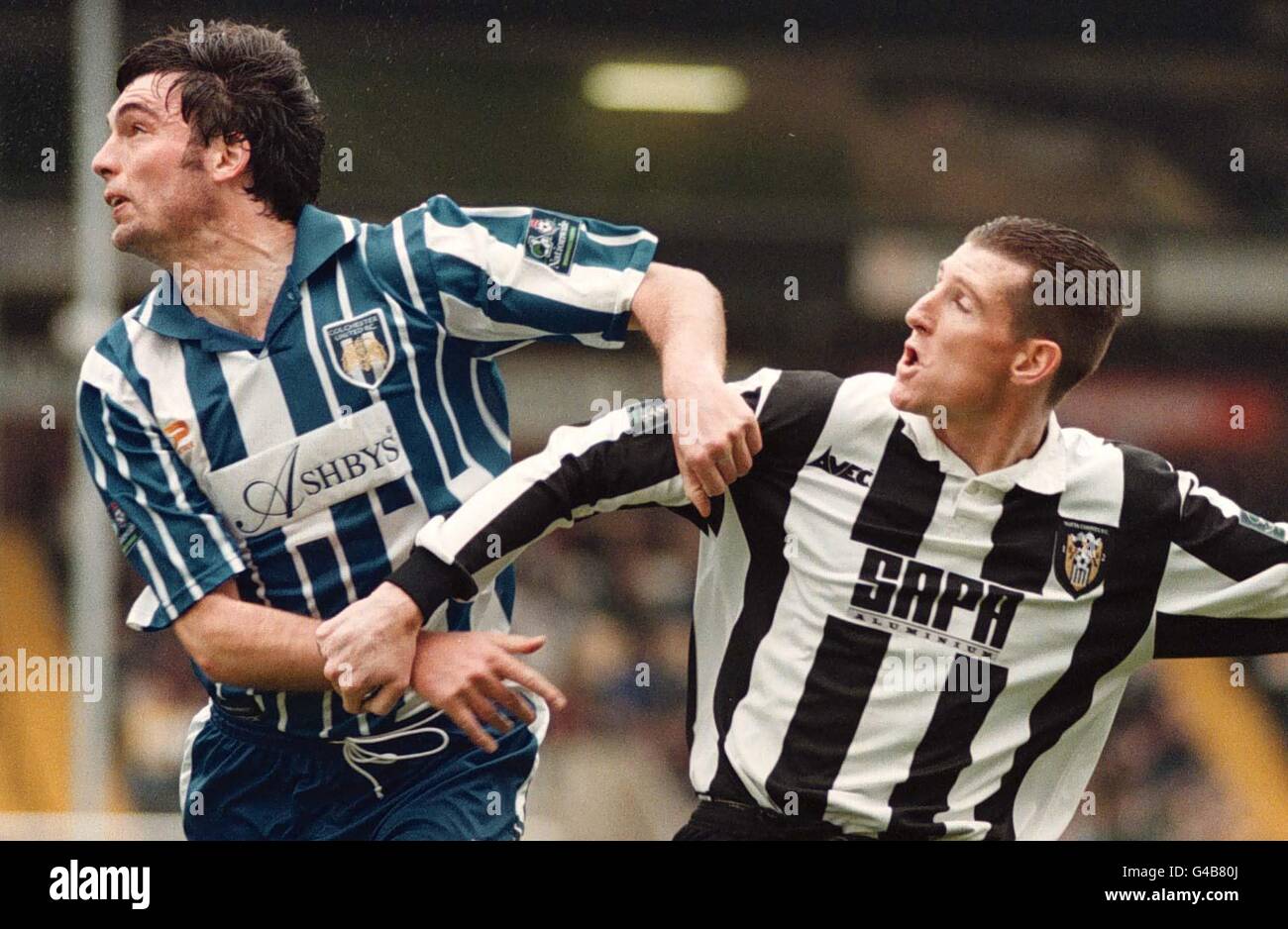 Colchester's David Green holds back Notts County's Gary Jones during ...
