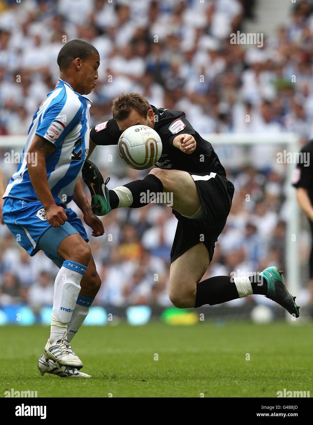 Huddersfield Town's Lee Peltier (left) and Peterborough United's ...