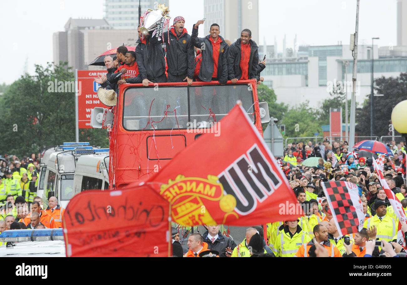The Manchester United team wave to fans on an open top bus during the ...