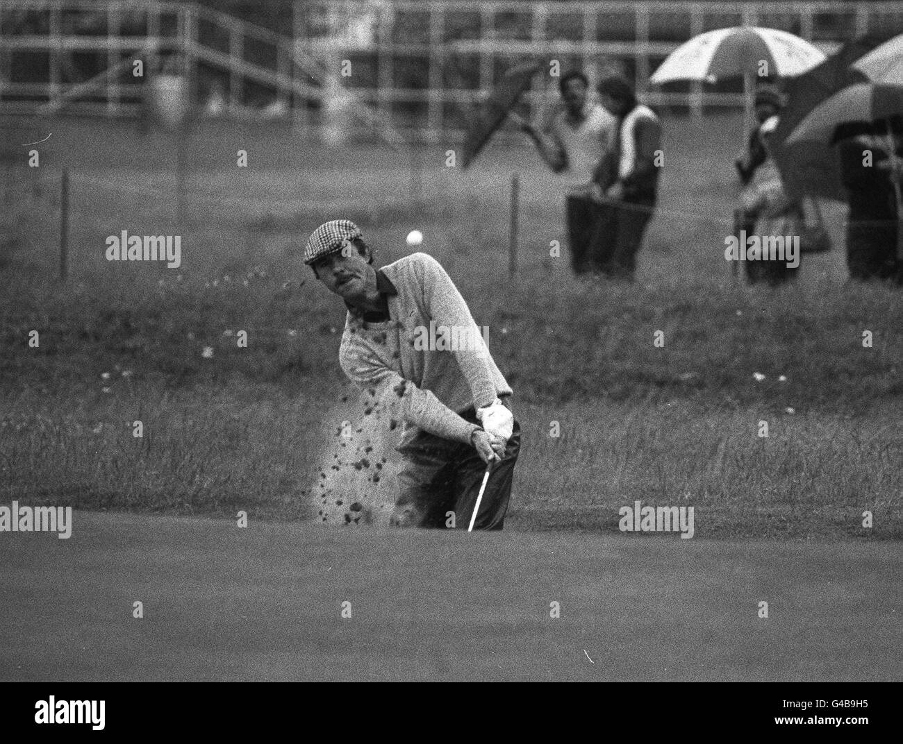 PA NEWS PHOTO 15/7/82 PETER COWEN BLASTS OUT OF A BUNKER ON THE FIRST ...