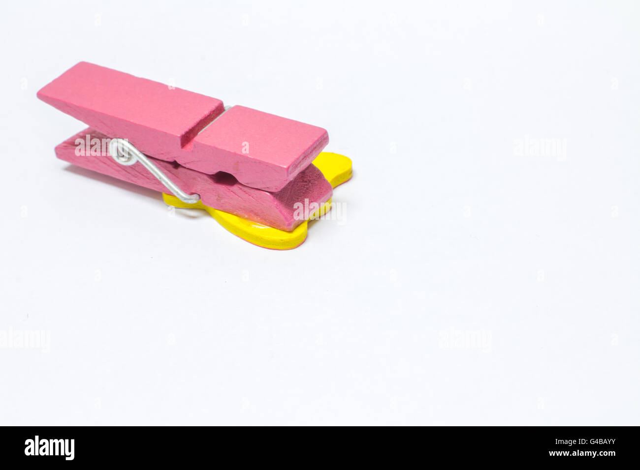 pink color wood peg on white background Stock Photo - Alamy