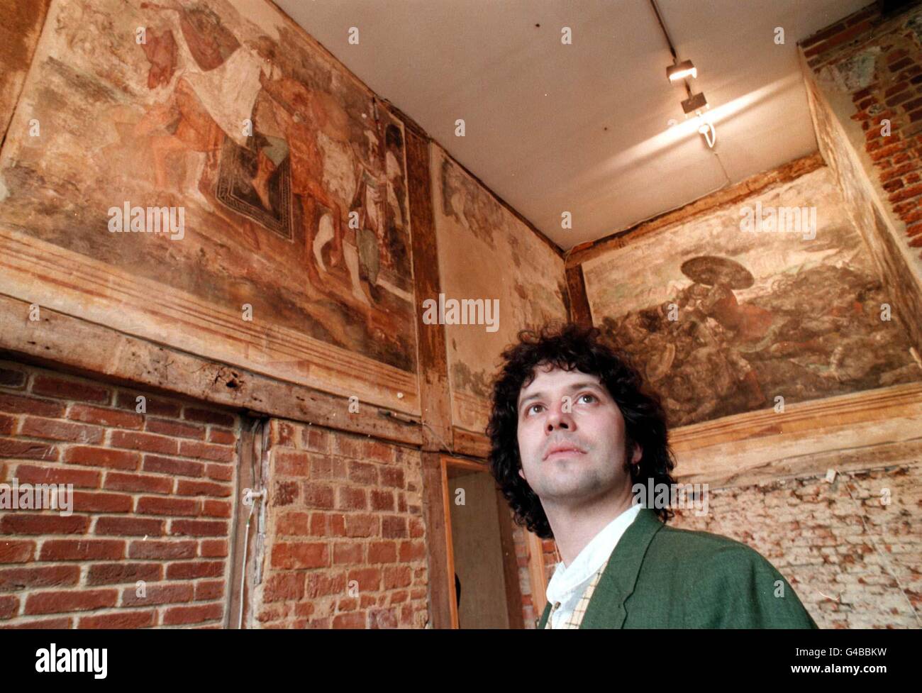 Adrian Heritage, a wall paintings expert, observes some works ...
