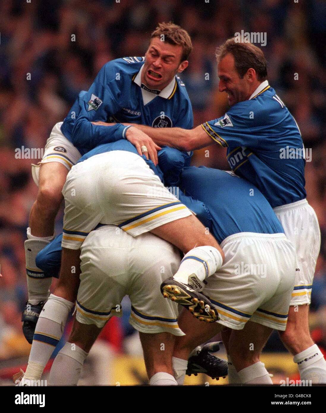 Duncan Ferguson (left) and Dave Watson (right) join the celebration as ...